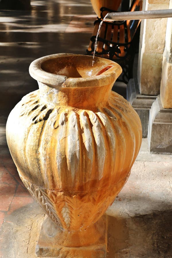 An Old Large Clay Jug into Which Flows a Stream of Water from a Tap ...