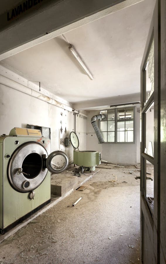 Creepy Old Laundry Room with a Dirty Floor and Broken Wash Machines and ...