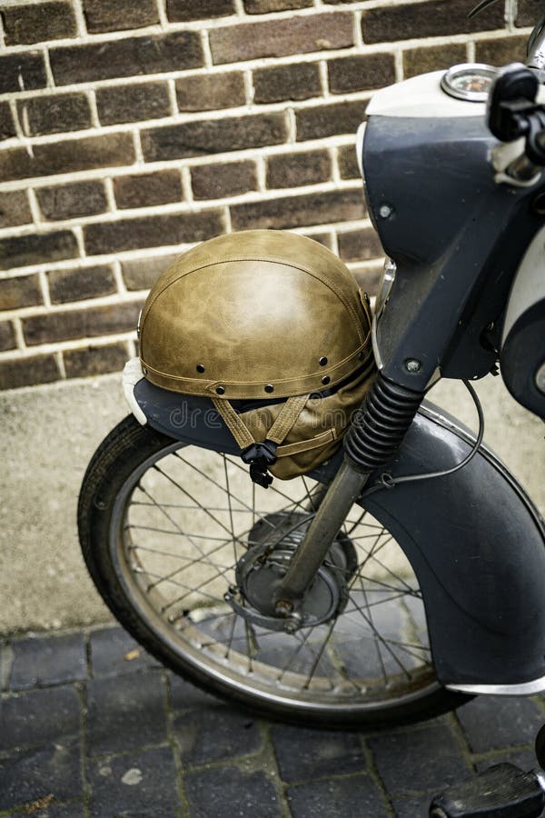 Old Leather Helmet from the Seventies on an Old Gray Moped Stock Photo ...