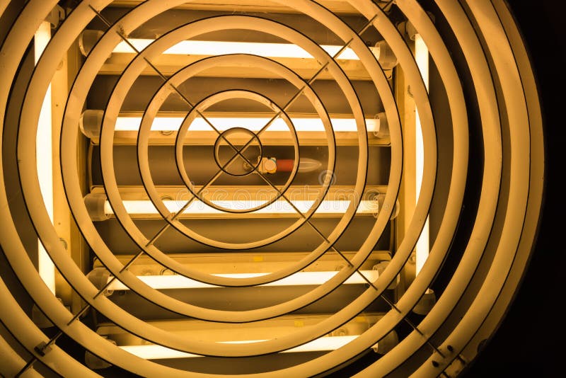 An Old Light Bulb in the Middle of Fluorescent Tubes Stock Image ...