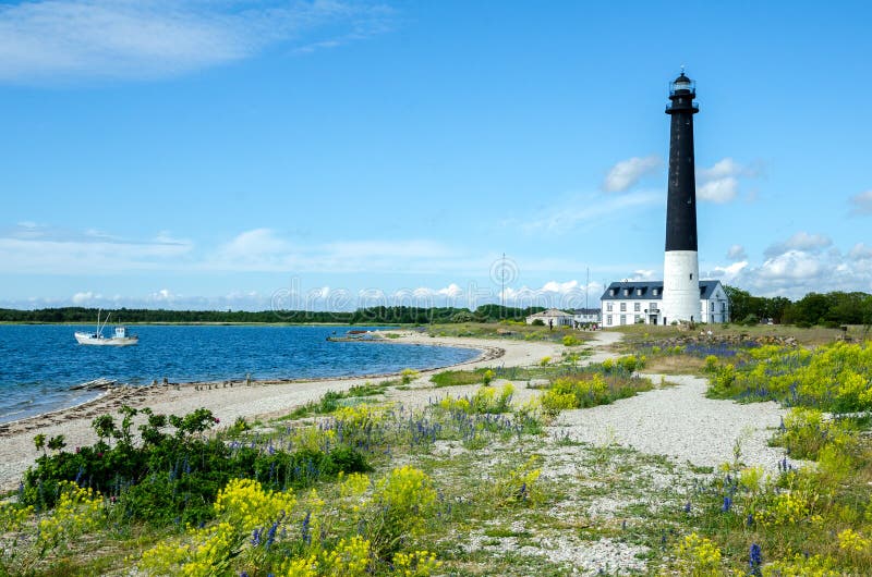 The Old Lighthouse on the Beach Stock Image - Image of seashore, boat ...