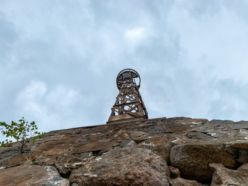 Old Lighthouse on the Beach, Surrounded by Rocks Stock Photo - Image of ...
