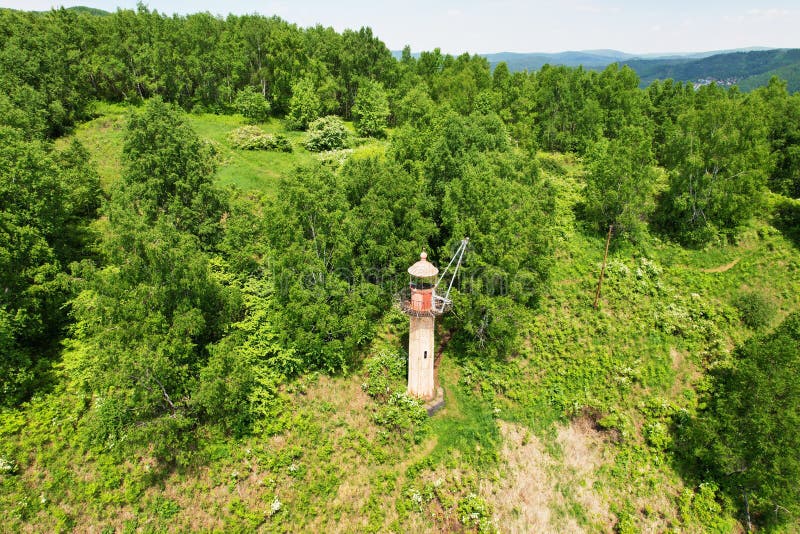 An Old Lighthouse on a Mountain Covered with Forest on a Summer Day ...
