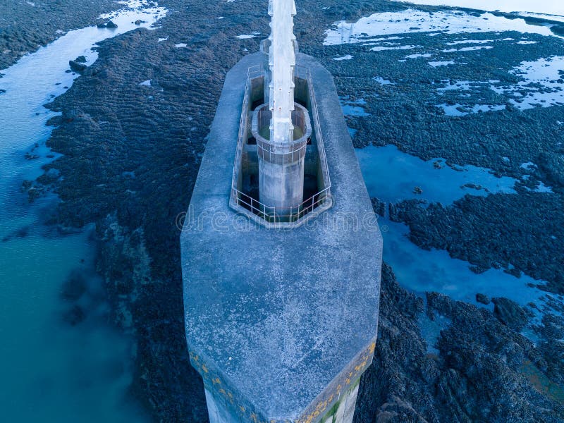 Old Lighthouse Standing on Rocks in the Middle of the Ocean Stock Photo ...