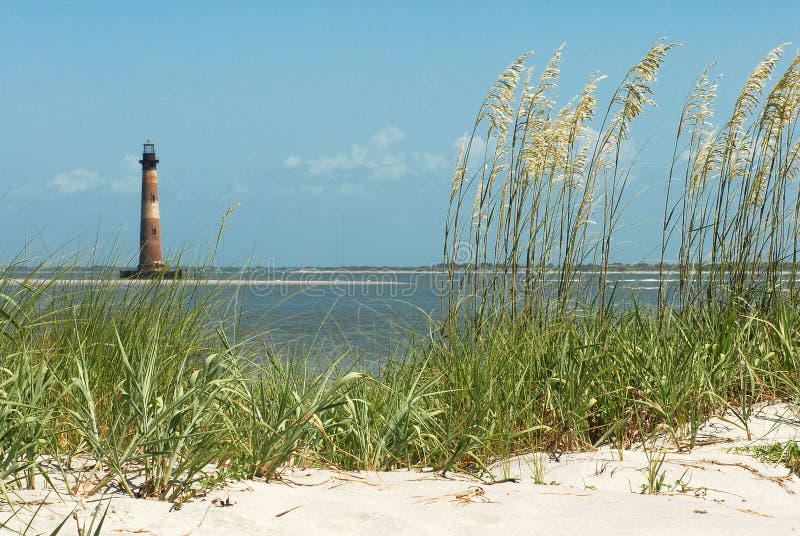 Old Lighthouse Tower at the Beach with Green Grass Stock Photo - Image ...