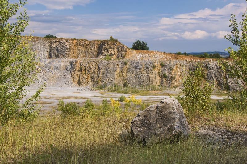 An Old Limestone Quarry with a Large Stone in the Foreground Stock ...