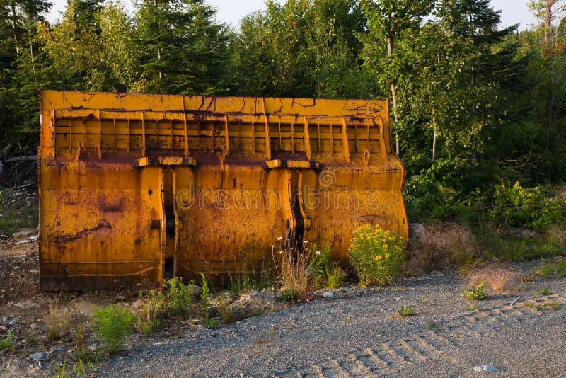 Old Loader Bucket on Side of Gravel Road in Summer Stock Image - Image ...
