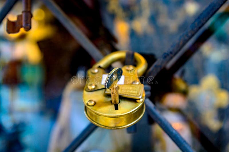 Old lock with a golden key stock image. Image of element - 226929885