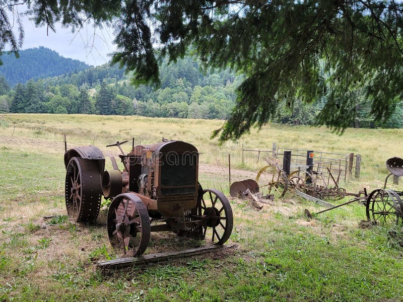 Old machines on a farm stock photo. Image of tractor - 272410410