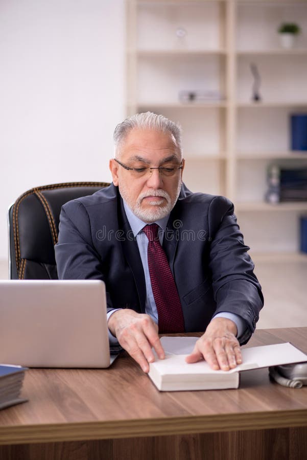 Old Male Boss Reading Book at Workplace Stock Image - Image of boss ...