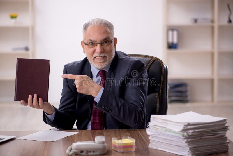 Old Male Boss Reading Book at Workplace Stock Image - Image of holding ...