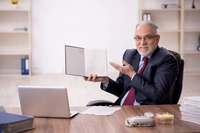 Old Male Boss Reading Book at Workplace Stock Photo - Image of business ...