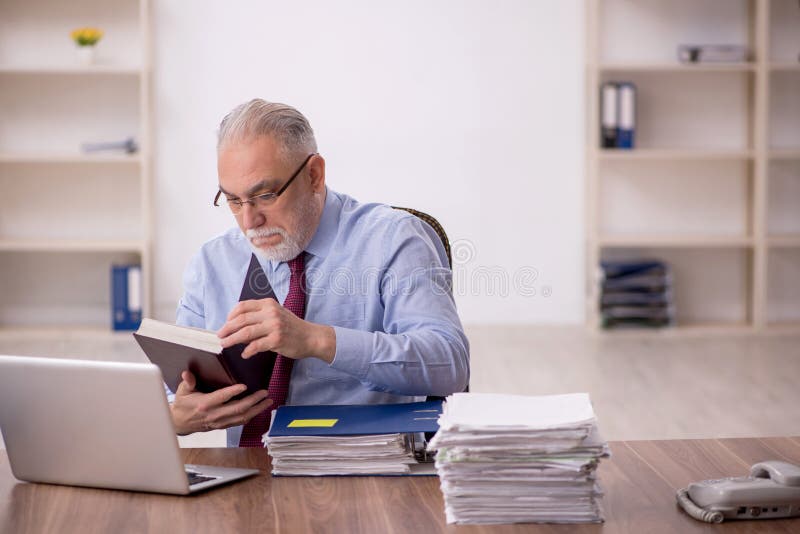 Old Male Boss Reading Book at Workplace Stock Photo - Image of ...