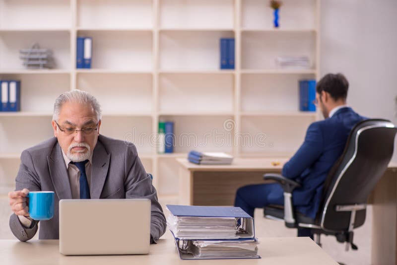 Old Male Boss and Young Male Employee in the Office Stock Photo - Image ...