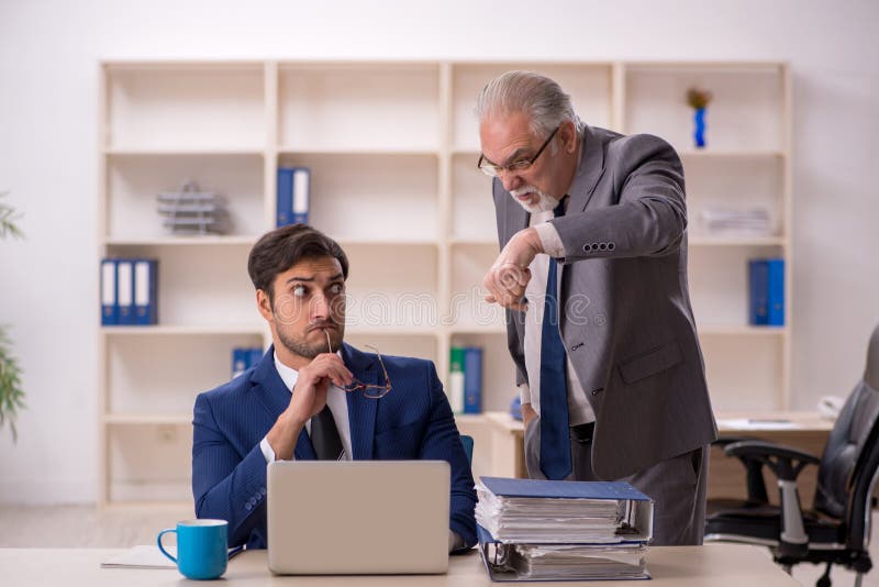 Old Male Boss and Young Male Employee in the Office Stock Photo - Image ...