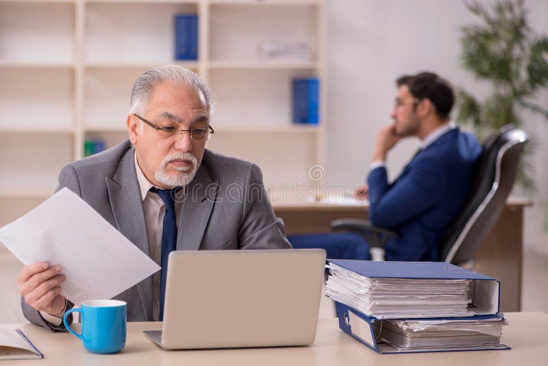 Old Male Boss and Young Male Employee in the Office Stock Photo - Image ...