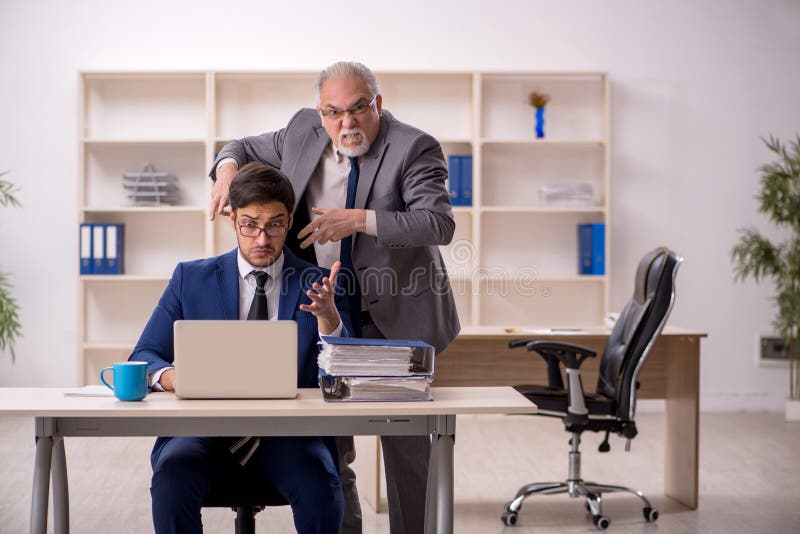 Old Male Boss and Young Male Employee in the Office Stock Photo - Image ...