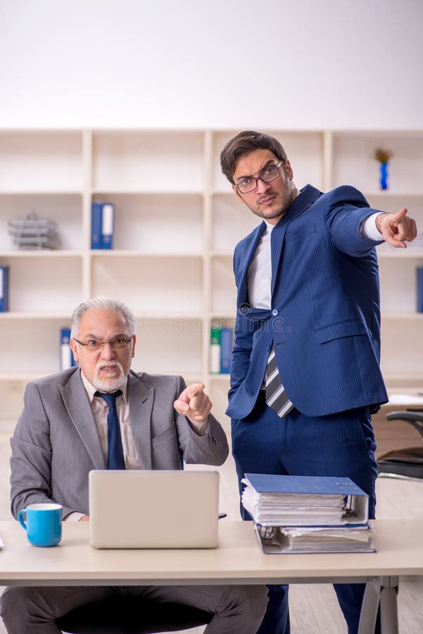Old Male Boss and Young Male Employee in the Office Stock Photo - Image ...