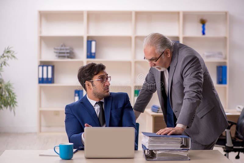 Old Male Boss and Young Male Employee in the Office Stock Photo - Image ...