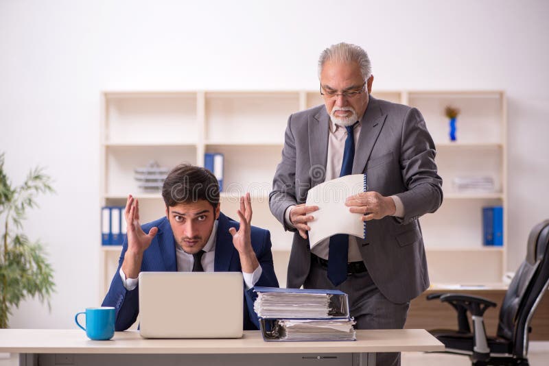 Old Male Boss and Young Male Employee in the Office Stock Photo - Image ...