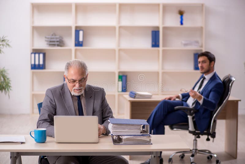 Old Male Boss and Young Male Employee in the Office Stock Photo - Image ...