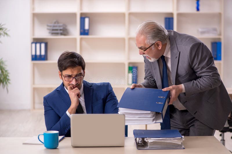 Old Male Boss and Young Male Employee in the Office Stock Photo - Image ...