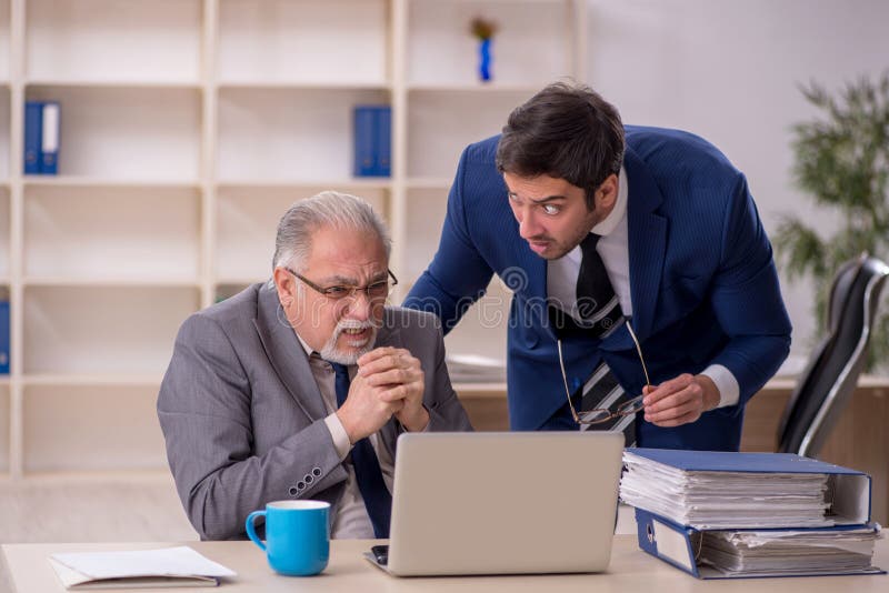 Old Male Boss and Young Male Employee in the Office Stock Photo - Image ...