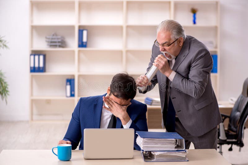 Old Male Boss and Young Male Employee in the Office Stock Photo - Image ...