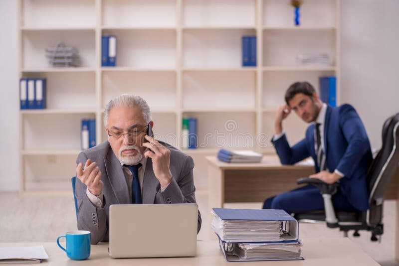 Old Male Boss and Young Male Employee in the Office Stock Photo - Image ...