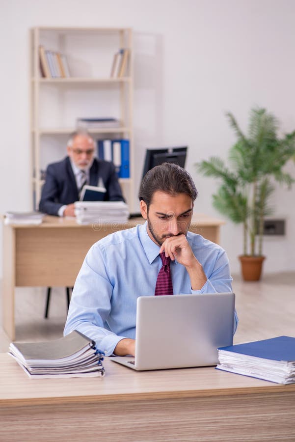 Old Male Boss and Young Employee Working in the Office Stock Photo ...