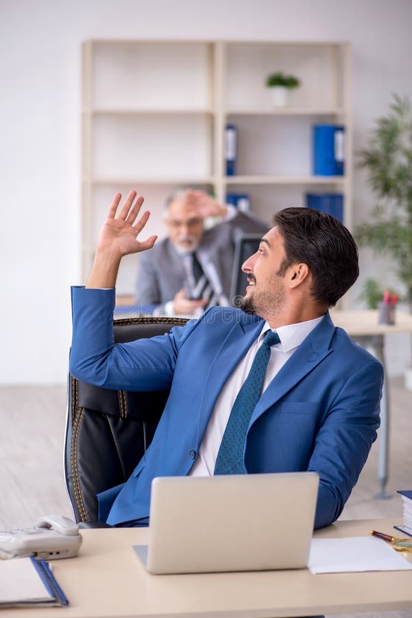 Old Male Boss and Young Male Employee Working in the Office Stock Photo ...