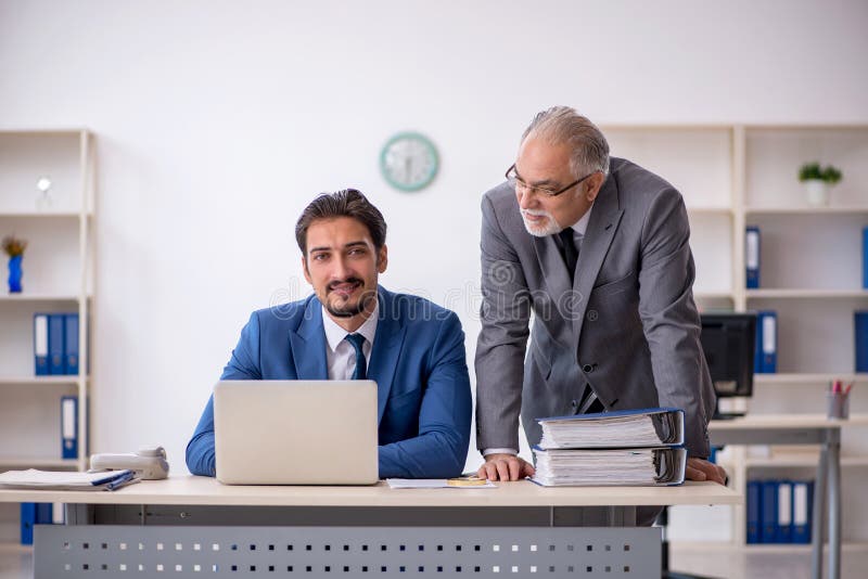 Old Male Boss and Young Male Employee Working in the Office Stock Photo ...