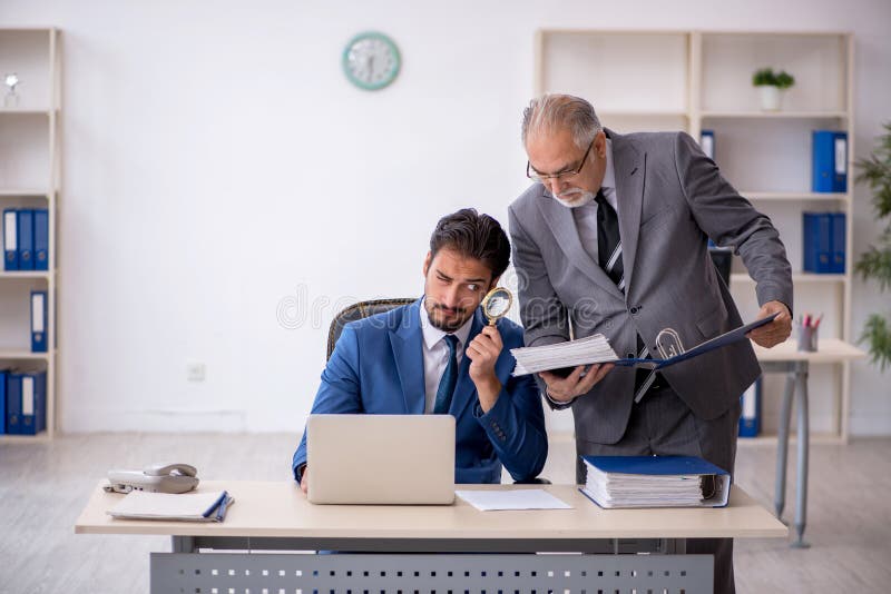 Old Male Boss and Young Male Employee Working in the Office Stock Photo ...