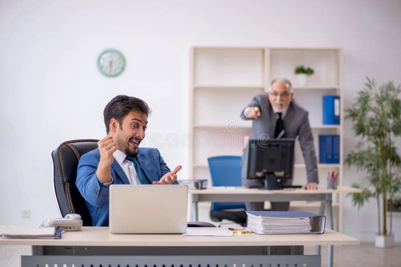 Old Male Boss and Young Male Employee Working in the Office Stock Photo ...
