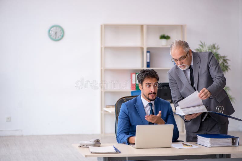 Old Male Boss and Young Male Employee Working in the Office Stock Image ...