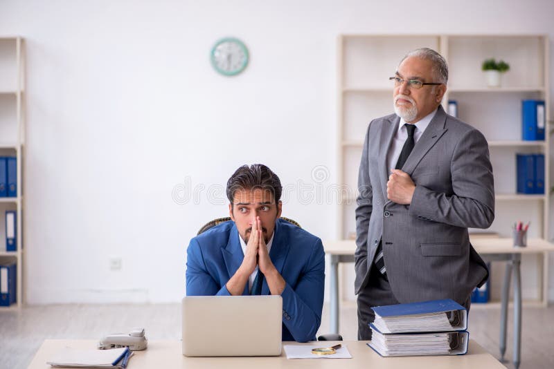 Old Male Boss and Young Male Employee Working in the Office Stock Photo ...