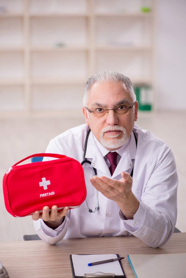 Old Male Doctor Holding First Aid Bag Stock Photo - Image of paramedic ...