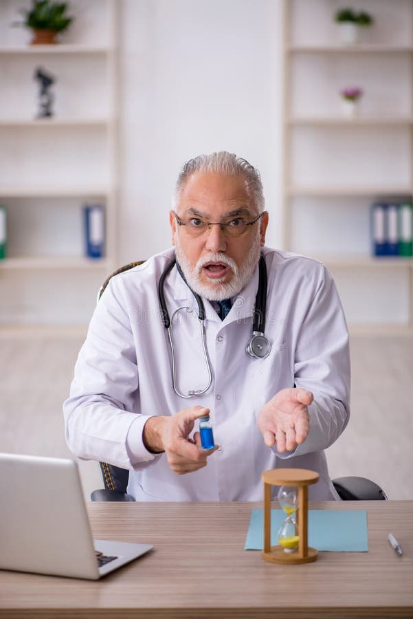 Old Male Doctor in Time Management Concept Stock Photo - Image of ...