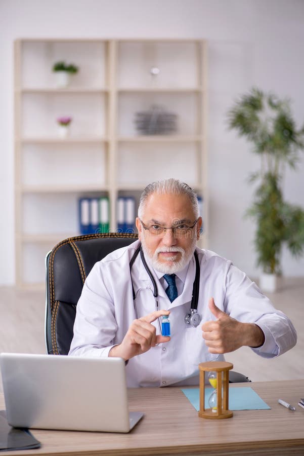 Old Male Doctor in Time Management Concept Stock Photo - Image of sand ...