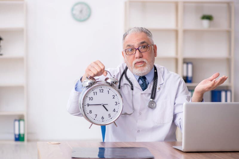 Old Male Doctor in Time Management Concept Stock Photo - Image of ...