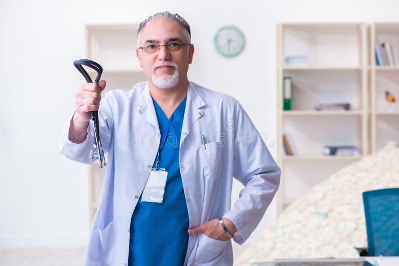 Old Male Doctor Working in the Clinic Stock Photo - Image of health ...
