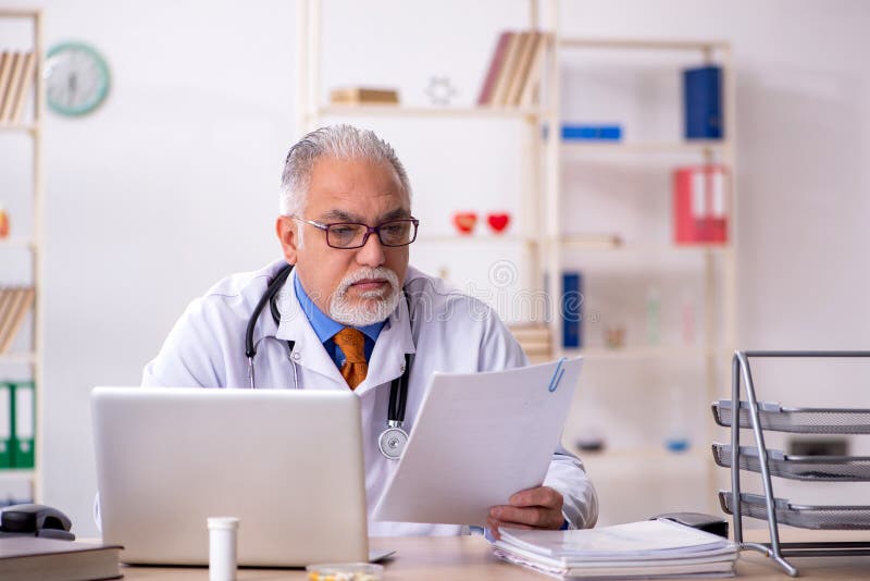 Old Male Doctor Working in the Clinic Stock Image - Image of agreement ...