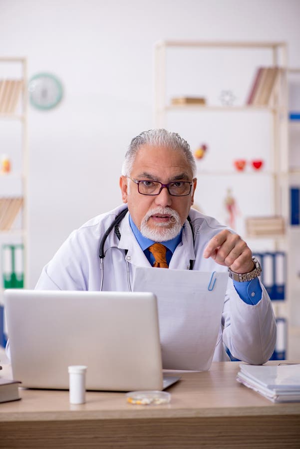 Old Male Doctor Working in the Clinic Stock Photo - Image of doctor ...