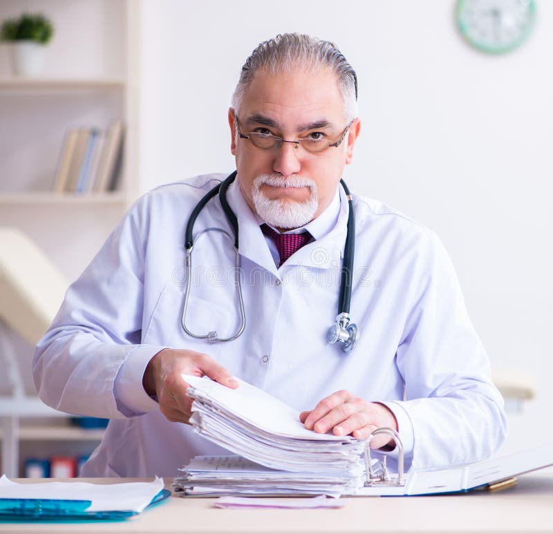 Old Male Doctor Working in the Clinic Stock Photo - Image of case ...