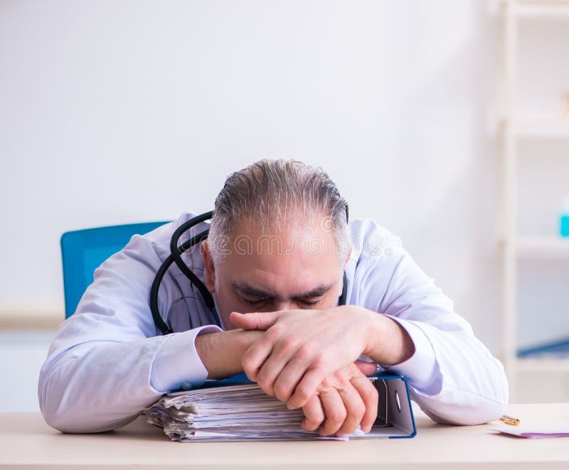 Old Male Doctor Working in the Clinic Stock Photo - Image of ...