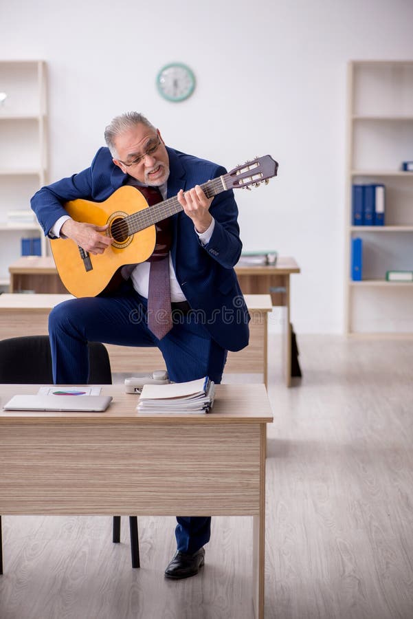 Old Male Employee Playing Guitar at Workplace Stock Image - Image of ...