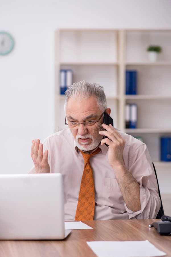 Old Male Employee Speaking by Phone at Workplace Stock Image - Image of ...
