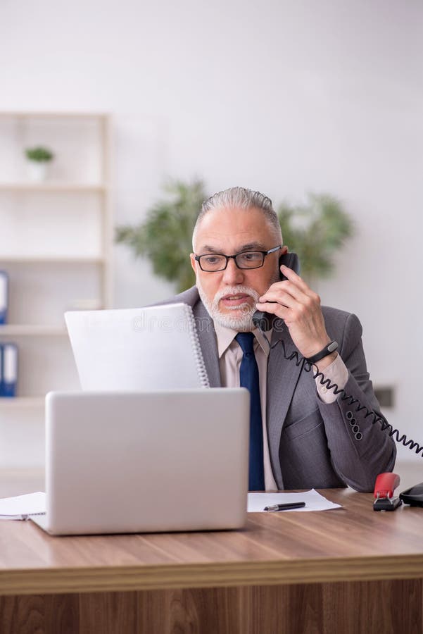 Old Male Employee Speaking by Phone at Workplace Stock Photo - Image of ...