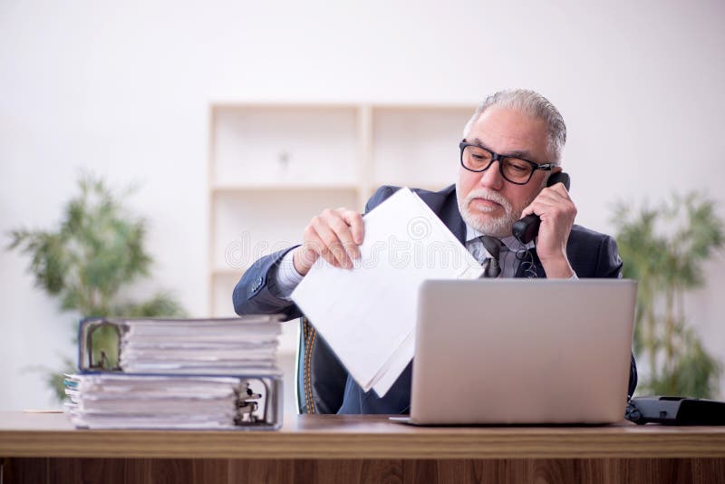 Old Male Employee and Too Much Work at Workplace Stock Photo - Image of ...