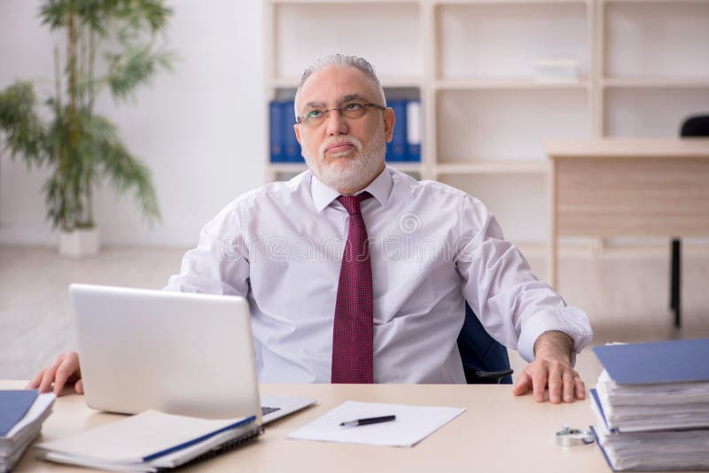 Old Male Employee and Too Much Work at Workplace Stock Photo - Image of ...
